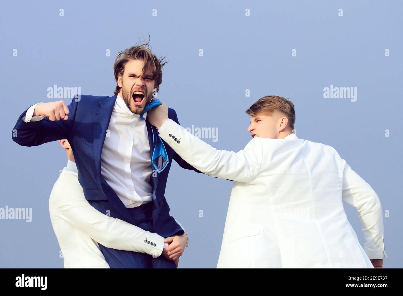Business man fighting. Group of business people fighting on blue sky ...