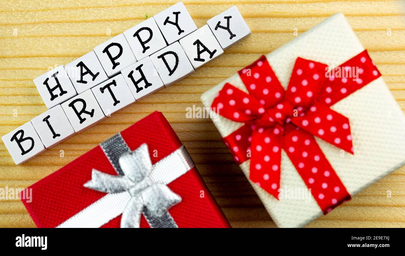 "Happy birthday" text arranged from blocks on a wooden background, next ...