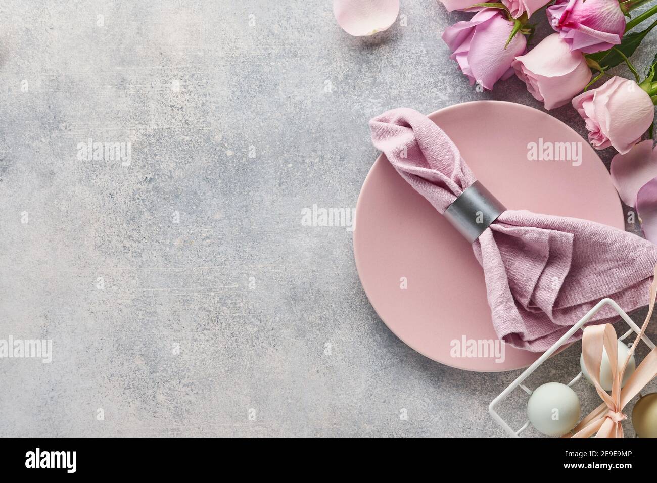 Easter table setting with floral decor on grey table. Elegance dinner ...