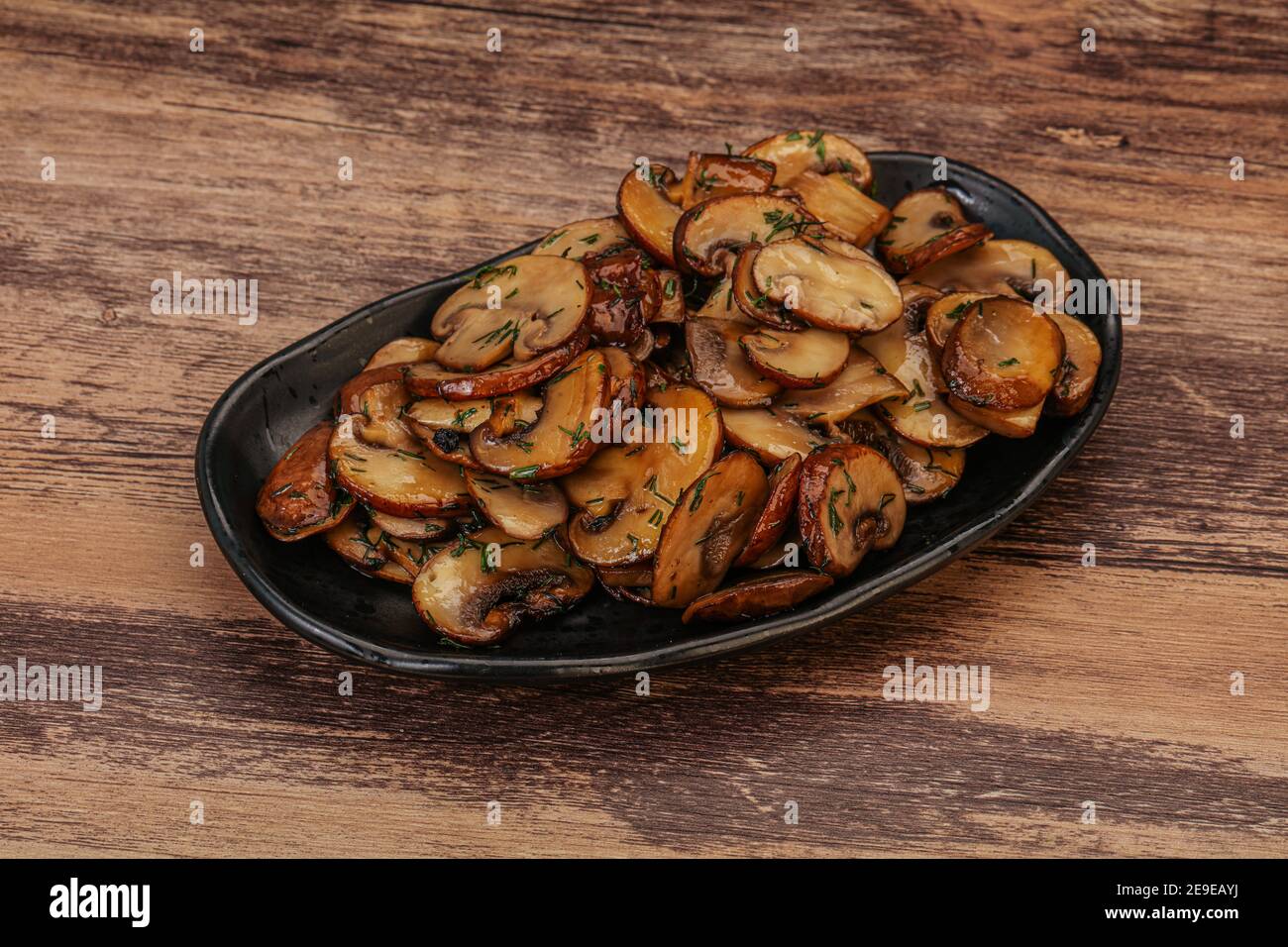Roasted champignon with herbs and spices in the bowl Stock Photo - Alamy