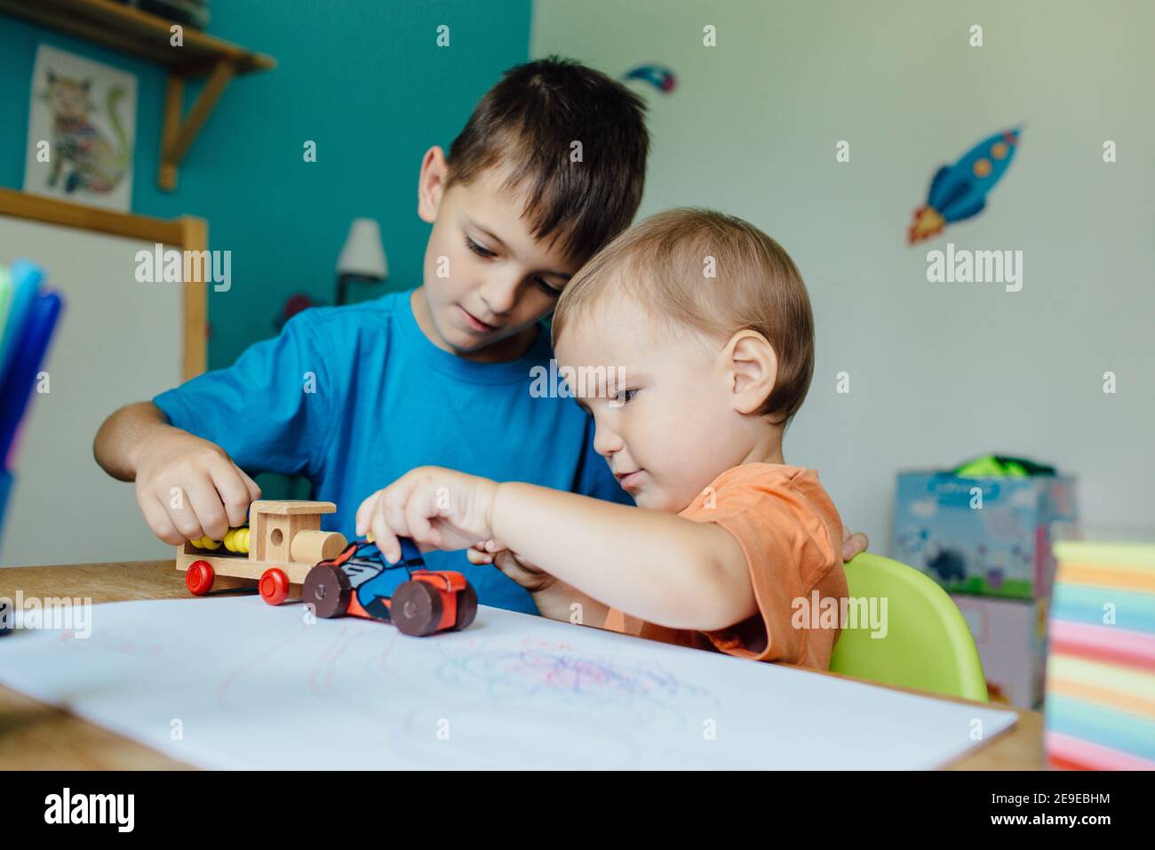 Two brothers playing together with toy cars Stock Photo - Alamy