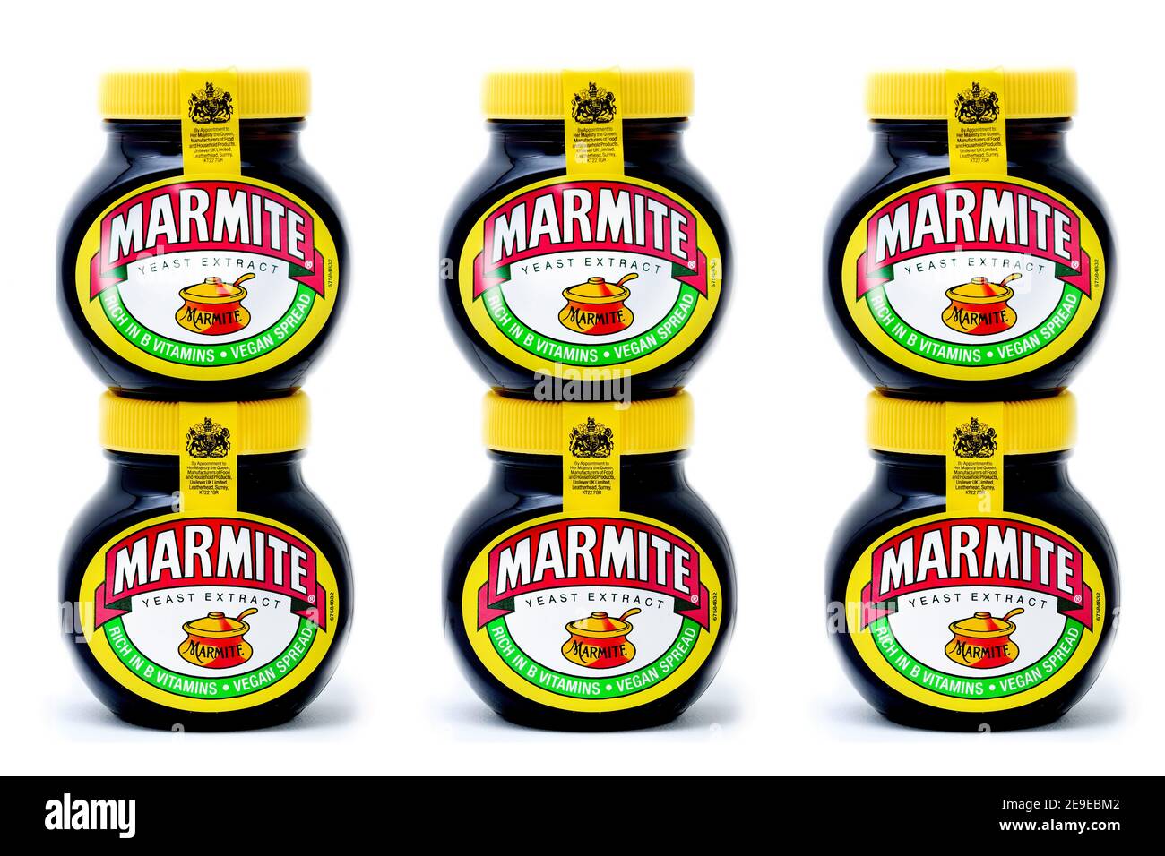 Six jars of Marmite, one on top of the other, photographed against a ...