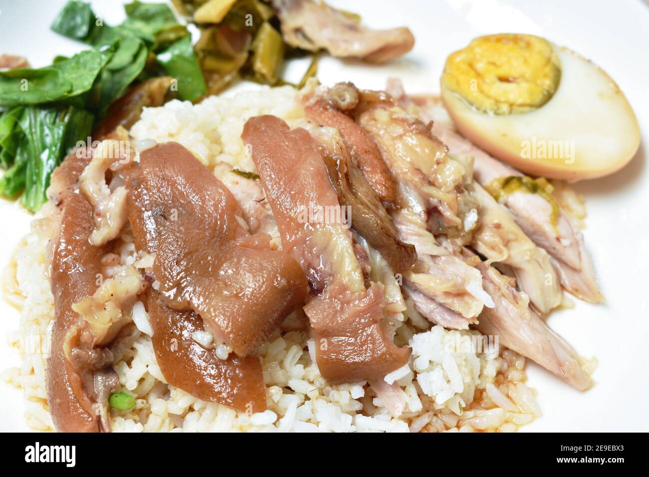 boiled pork leg slice in black Chinese herb soup with egg dipping spicy ...