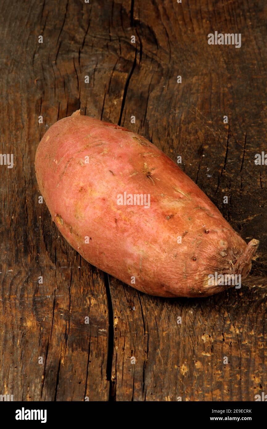 Raw sweet potato or batatas on old wooden board. Batatas on wooden ...