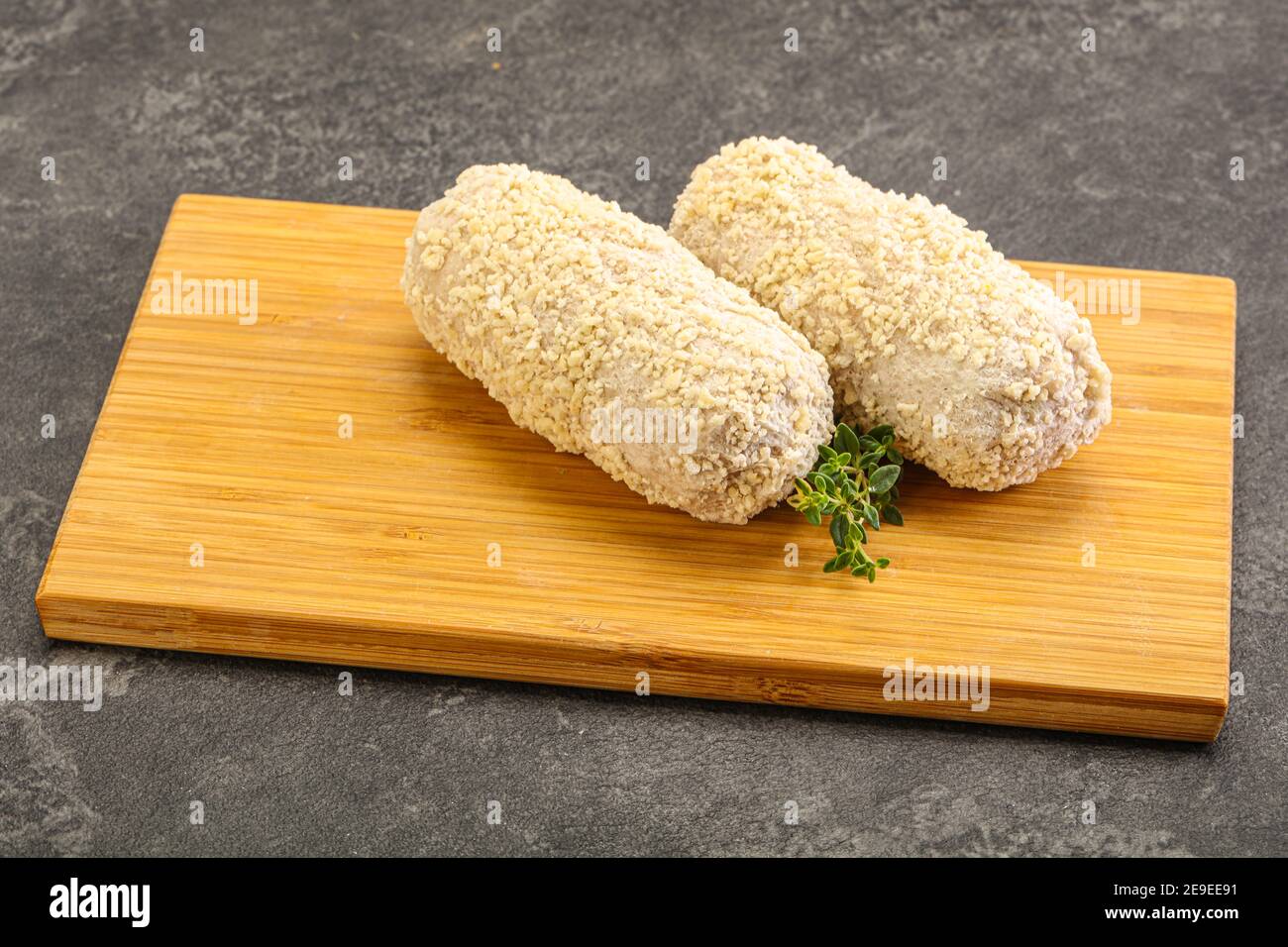 Raw breaded chicken cutlet for roast Stock Photo - Alamy