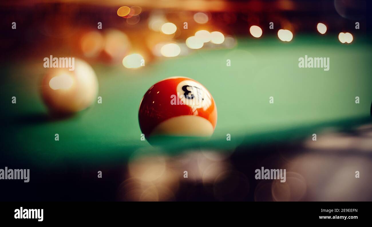 Billiard ball with number thirteen on a green billiard table. Gambling ...