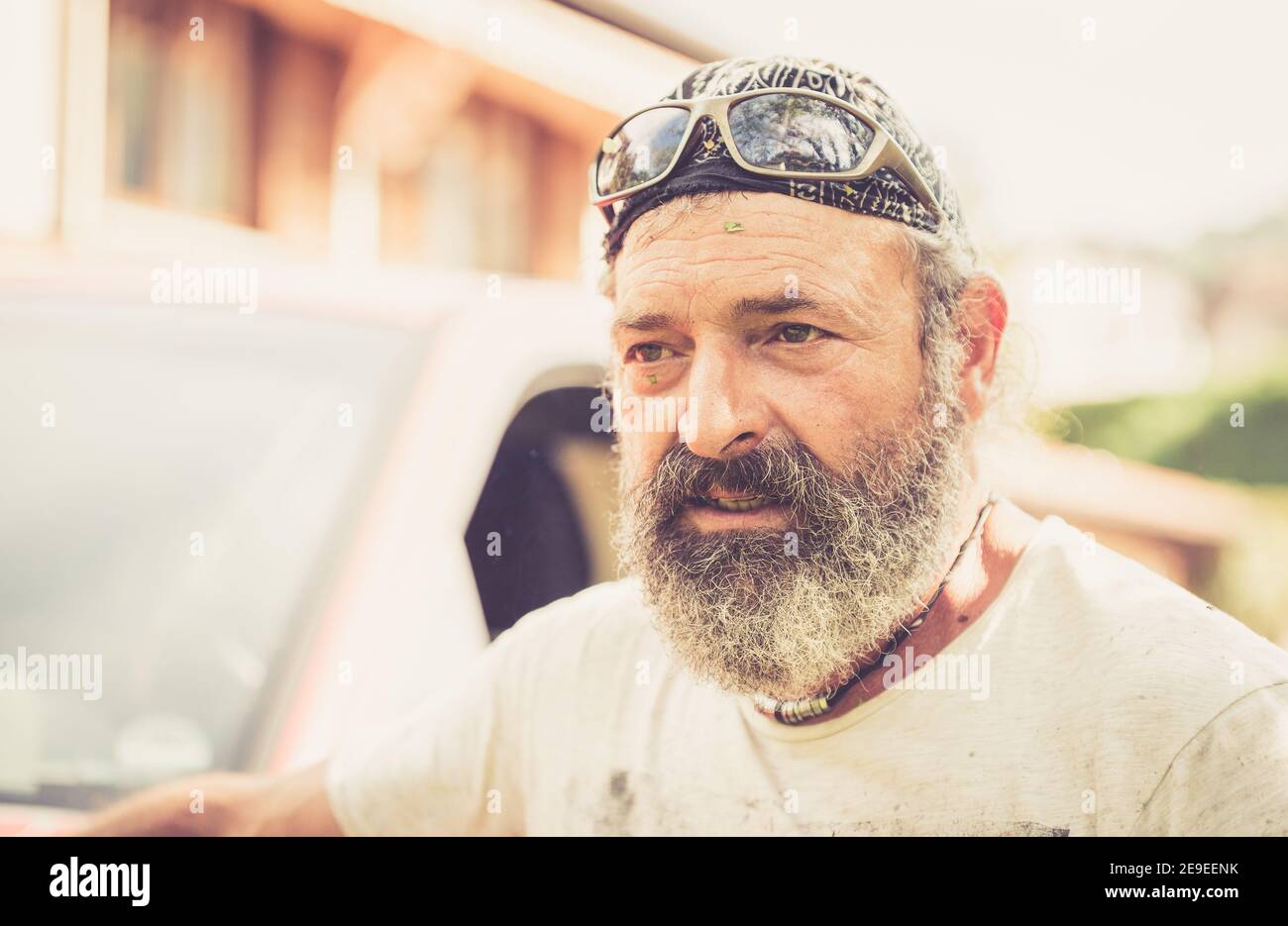 Portrait of tired bearded man con sweat on his face after hard work in ...