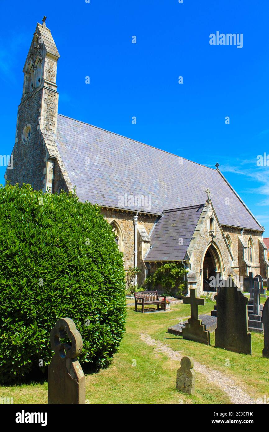 Exterior view of St John the Evangelist anglican church with tombstones ...