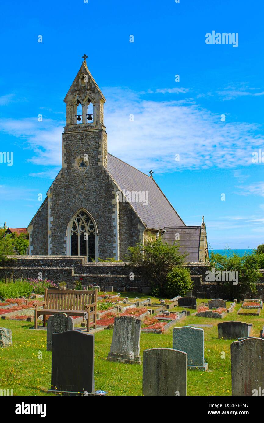 Exterior view of St John the Evangelist anglican church with tombstones ...