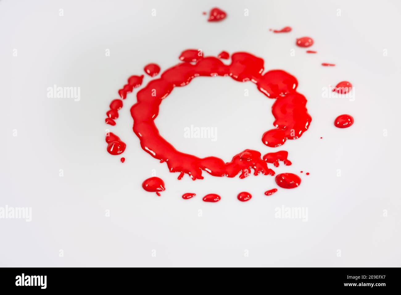 Red ink dripping circles on the ground of a rotating white object Stock ...