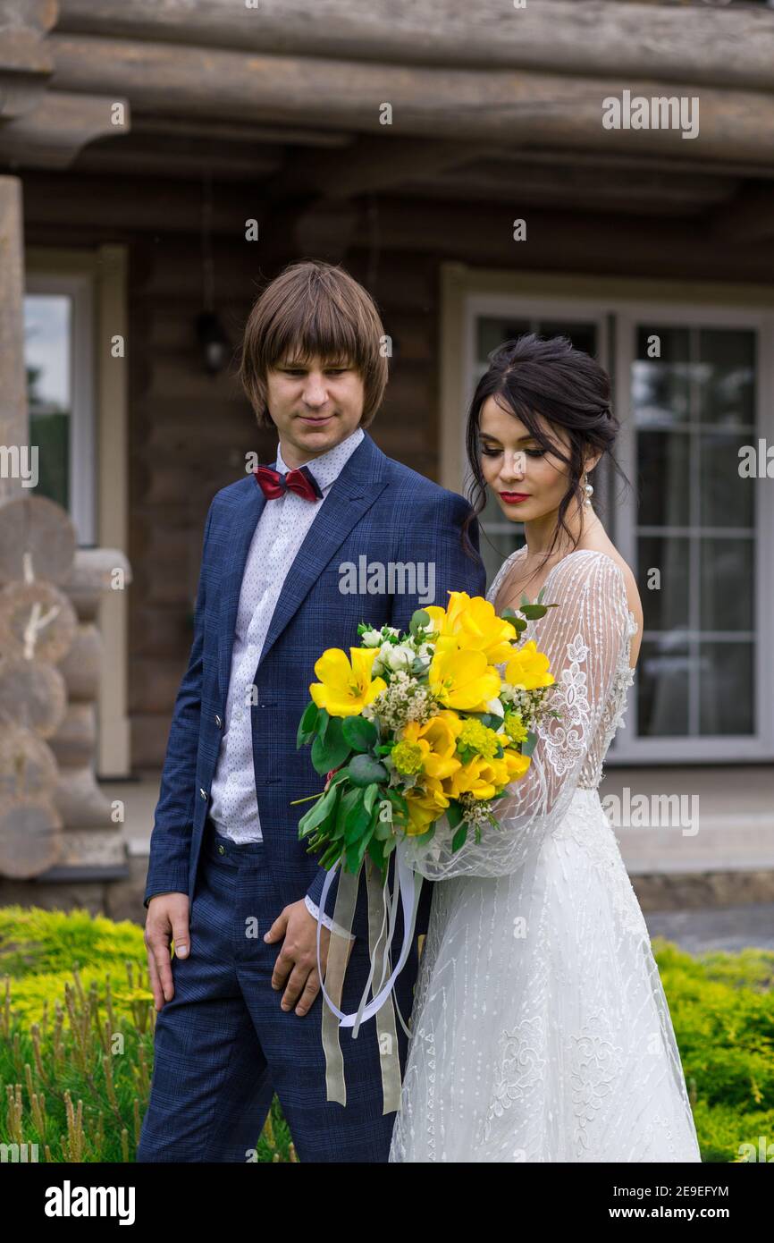 Newly married posing near by luxurious wooden mansion on wedding ...