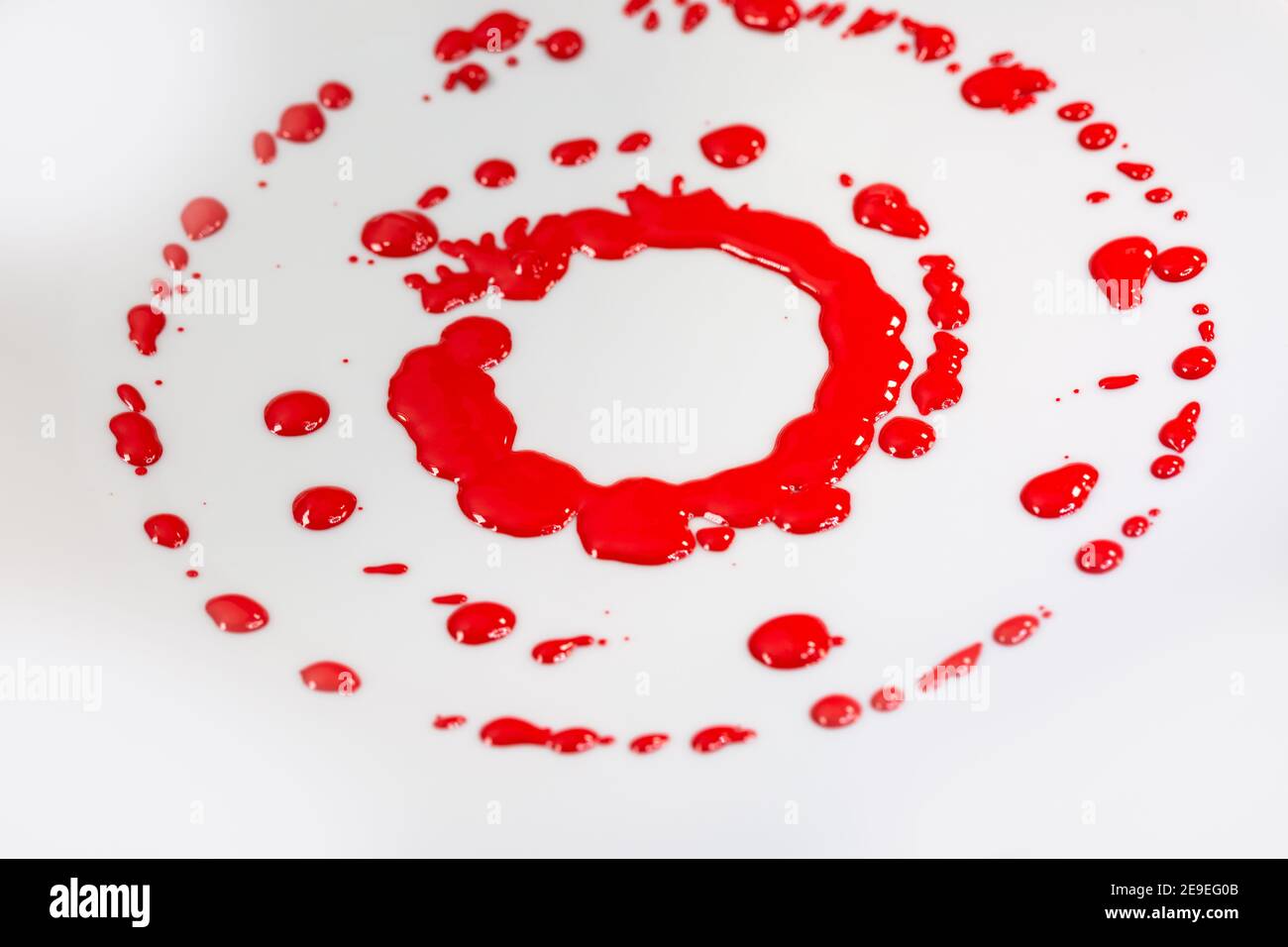 Red ink dripping circles on the ground of a rotating white object Stock ...