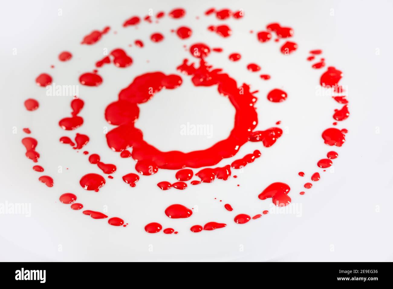 Red ink dripping circles on the ground of a rotating white object Stock ...