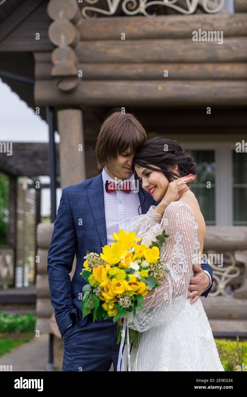 Newly married posing near by luxurious wooden mansion on wedding ...