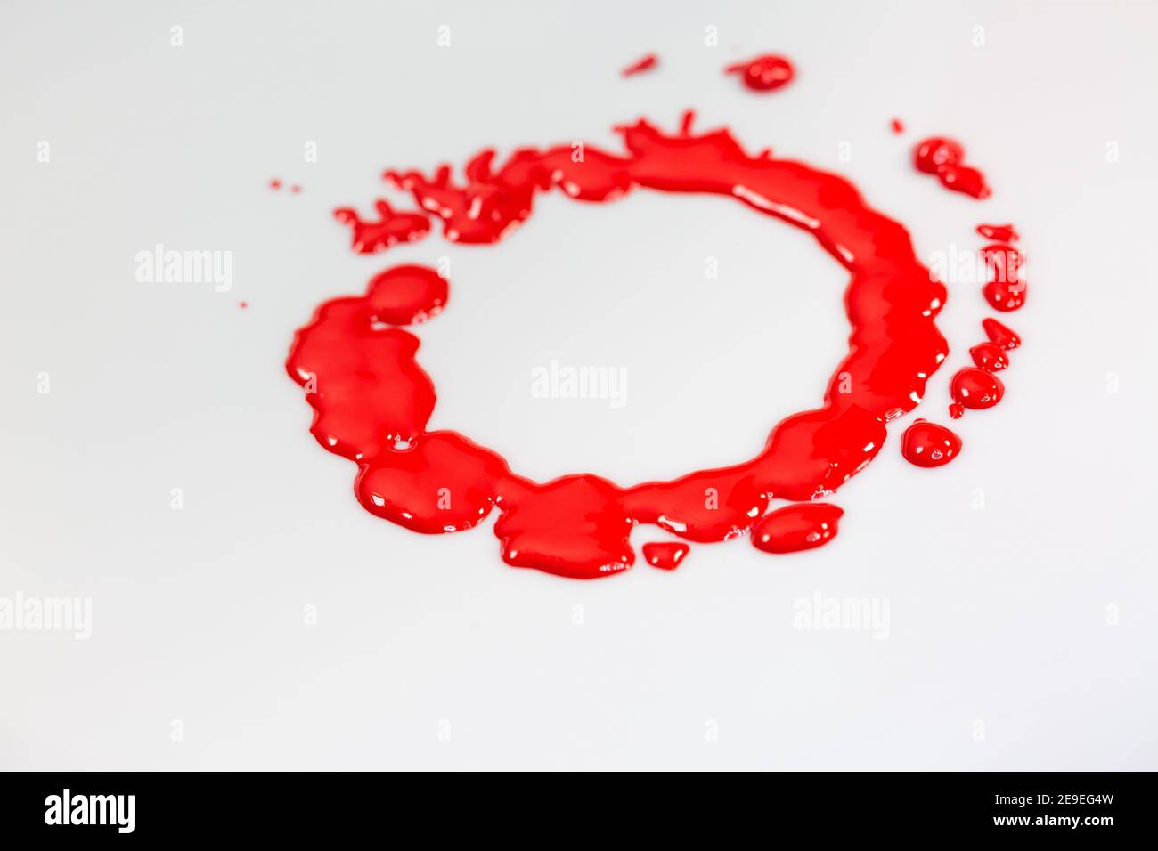 Red ink dripping circles on the ground of a rotating white object Stock ...
