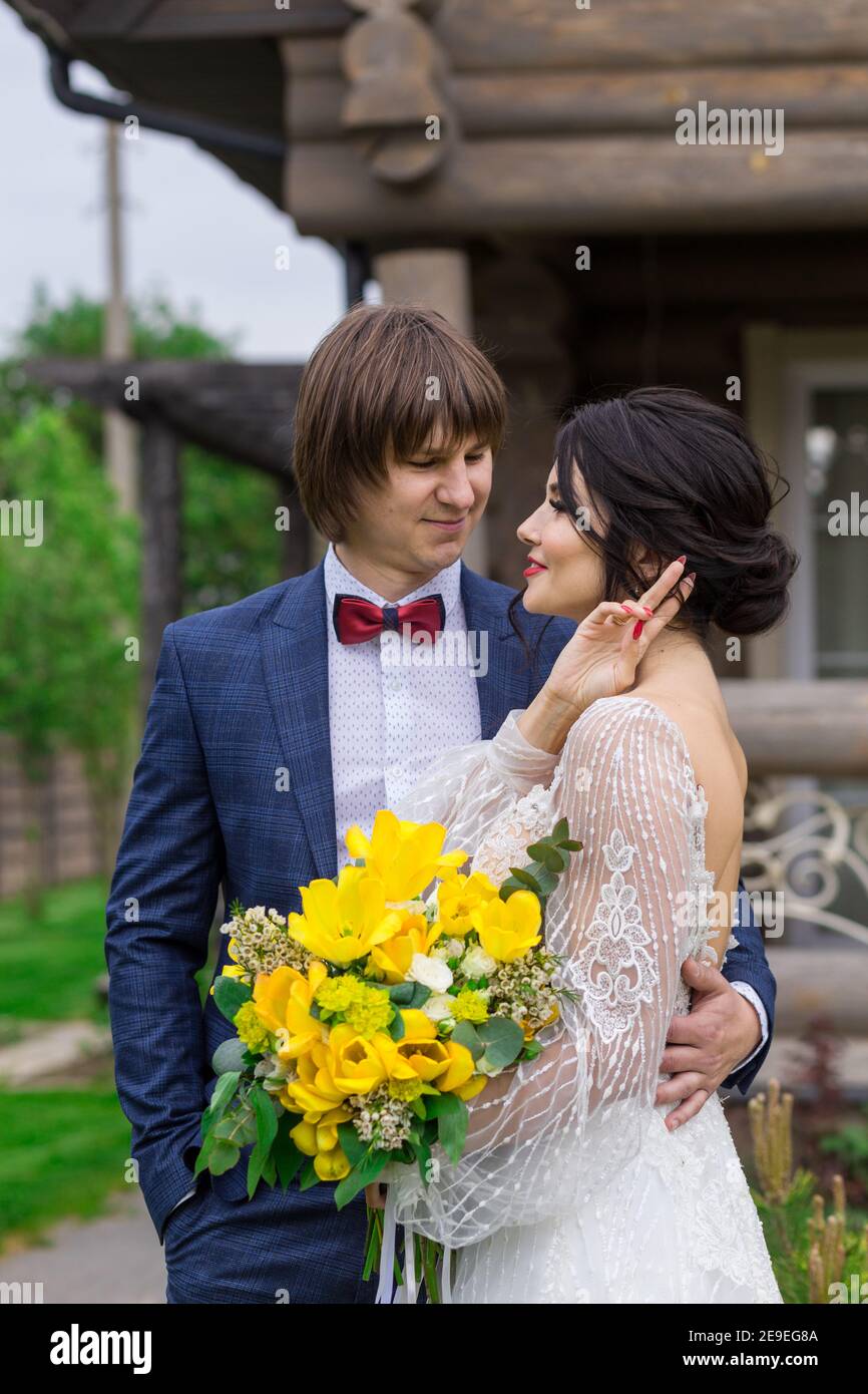 Newly married posing near by luxurious wooden mansion on wedding ...