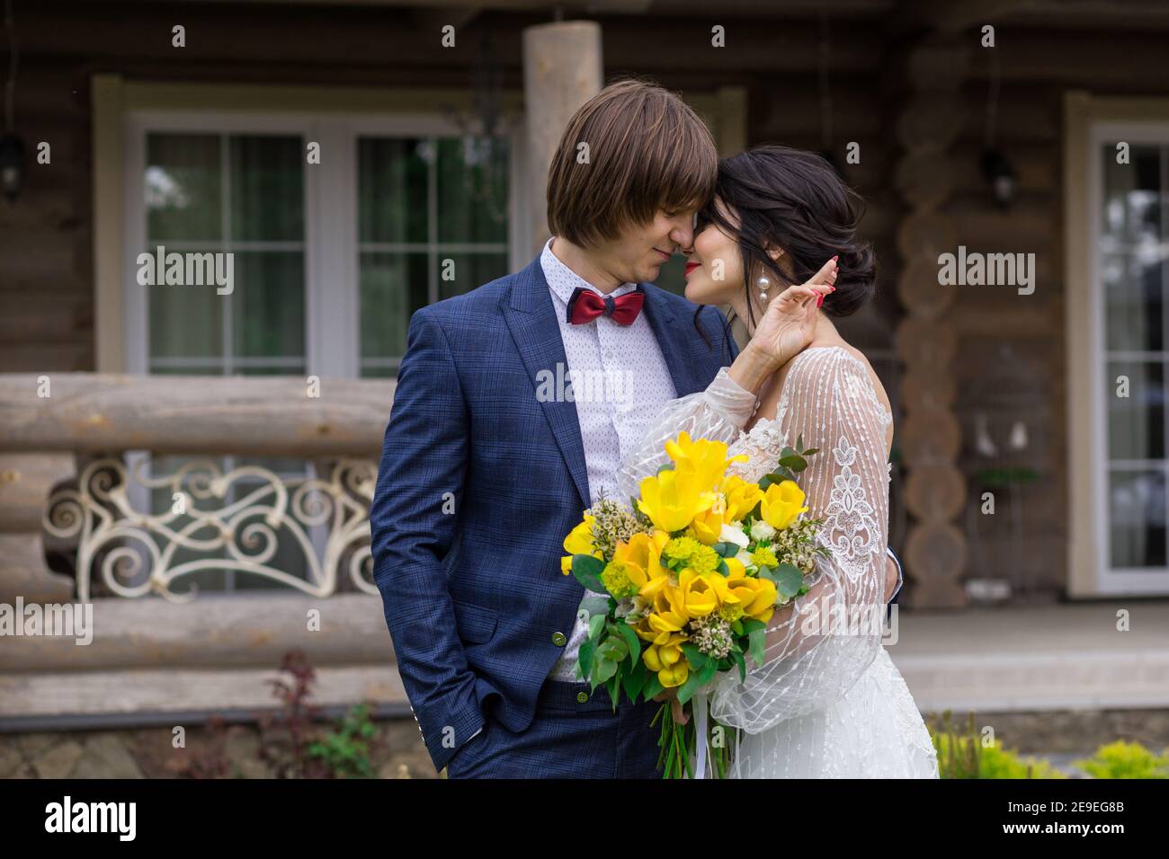 Newly married posing near by luxurious wooden mansion on wedding ...