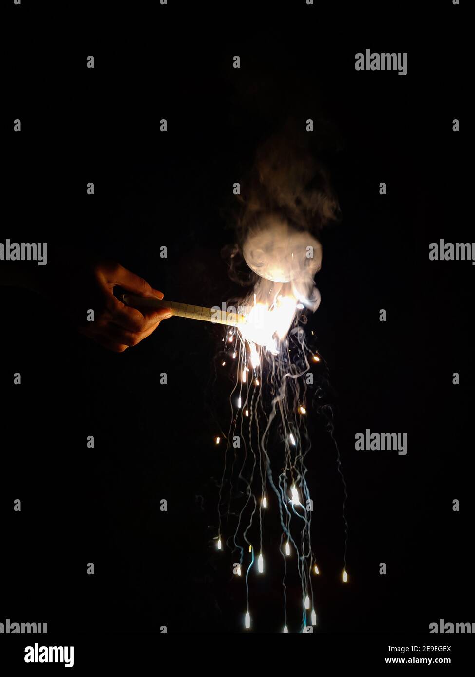 Hand holding a firework stick burning at night Stock Photo - Alamy