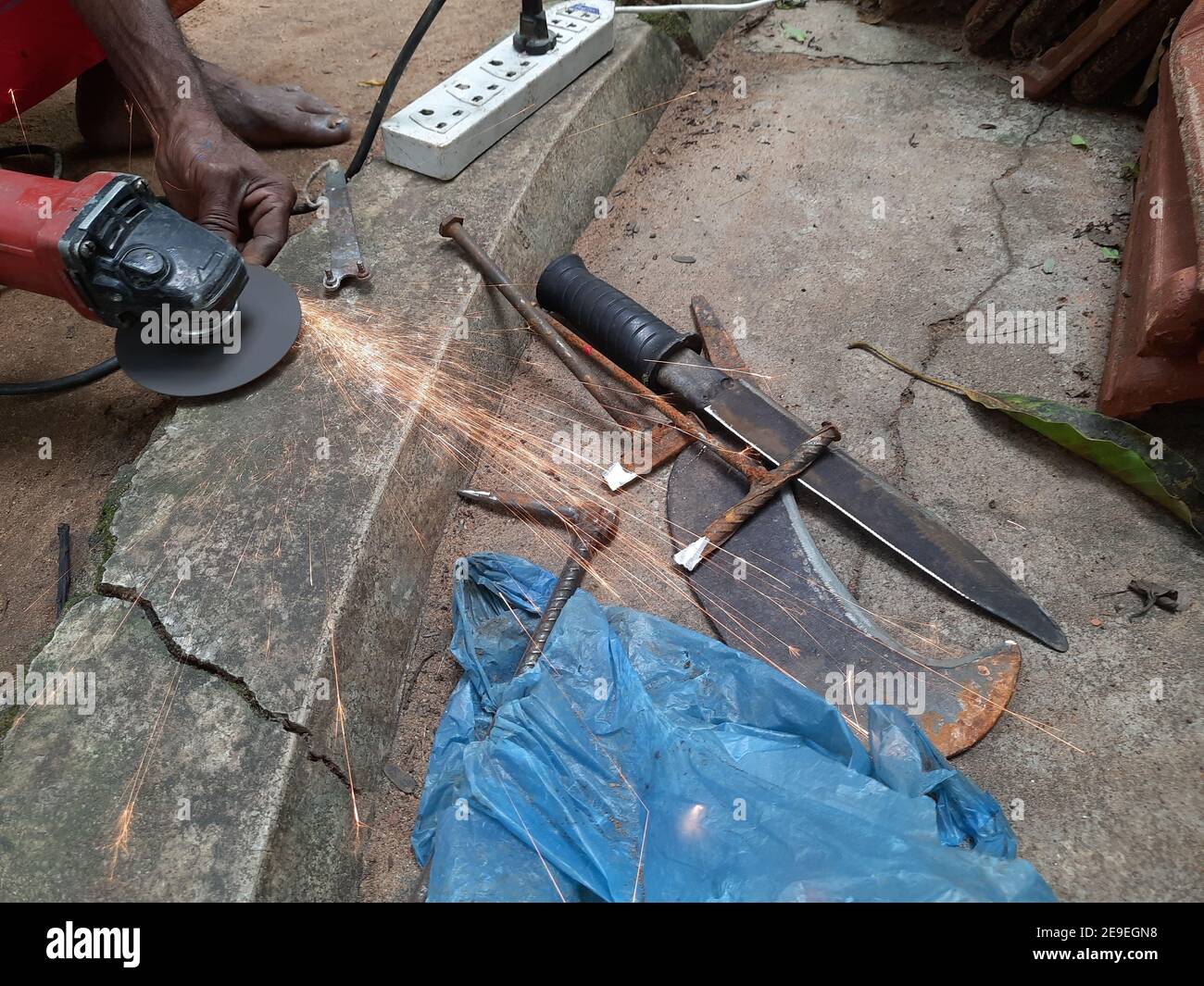 Black male working on steel with an electrical metalworking tool Stock ...