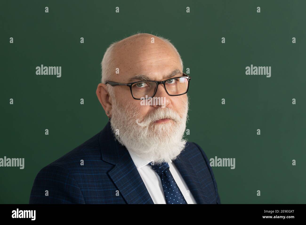 Serious teacher. Closeup portrait of senior academic professor near ...