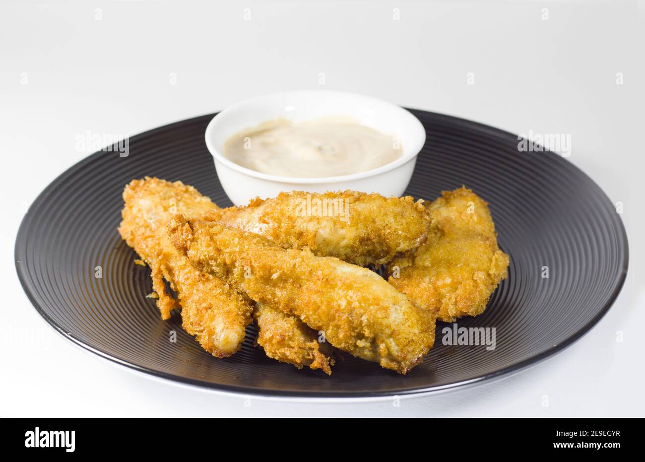 Plate of crispy Chicken nuggets with a sauce Stock Photo - Alamy