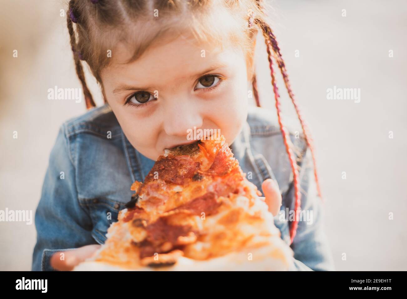 Child eating pizza. Fastfood for kids. Junkfood addiction. Italian ...