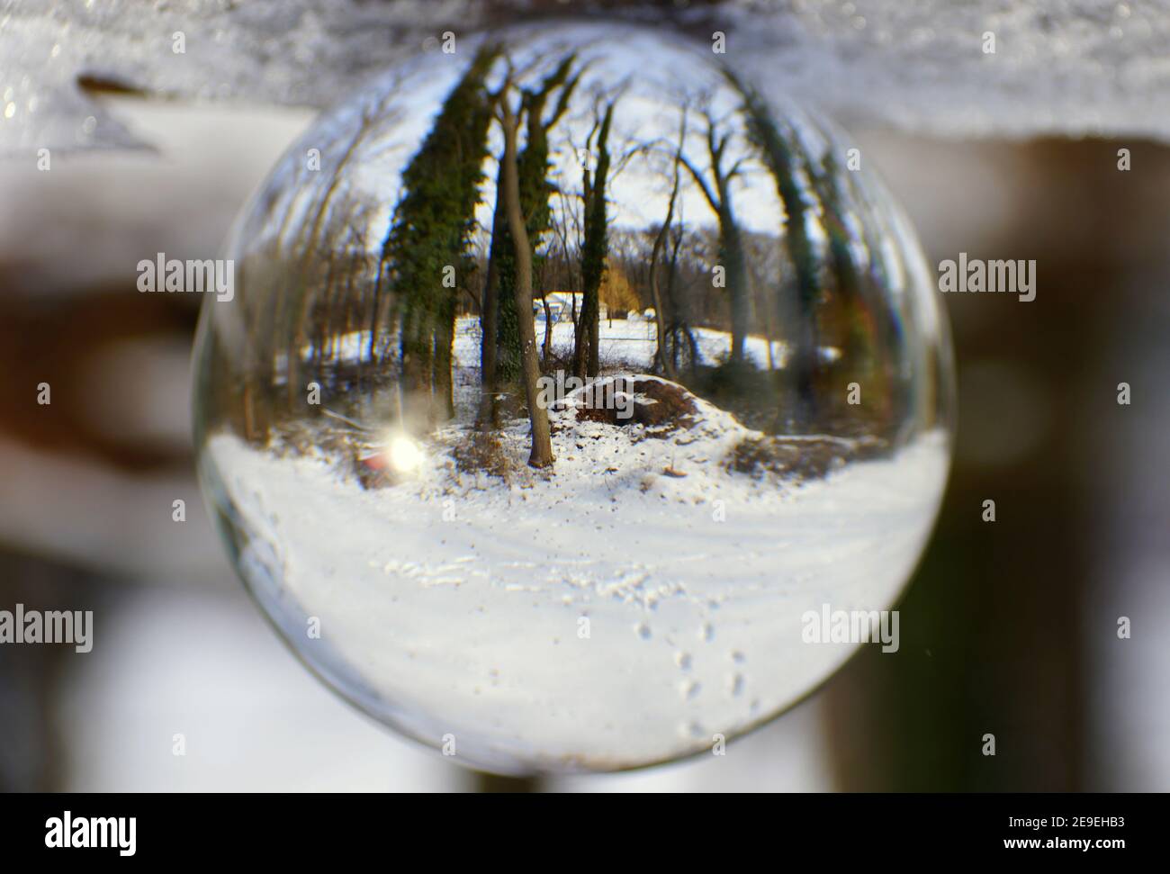 Beautiful landscape with snow captured through a crystal lens ball ...