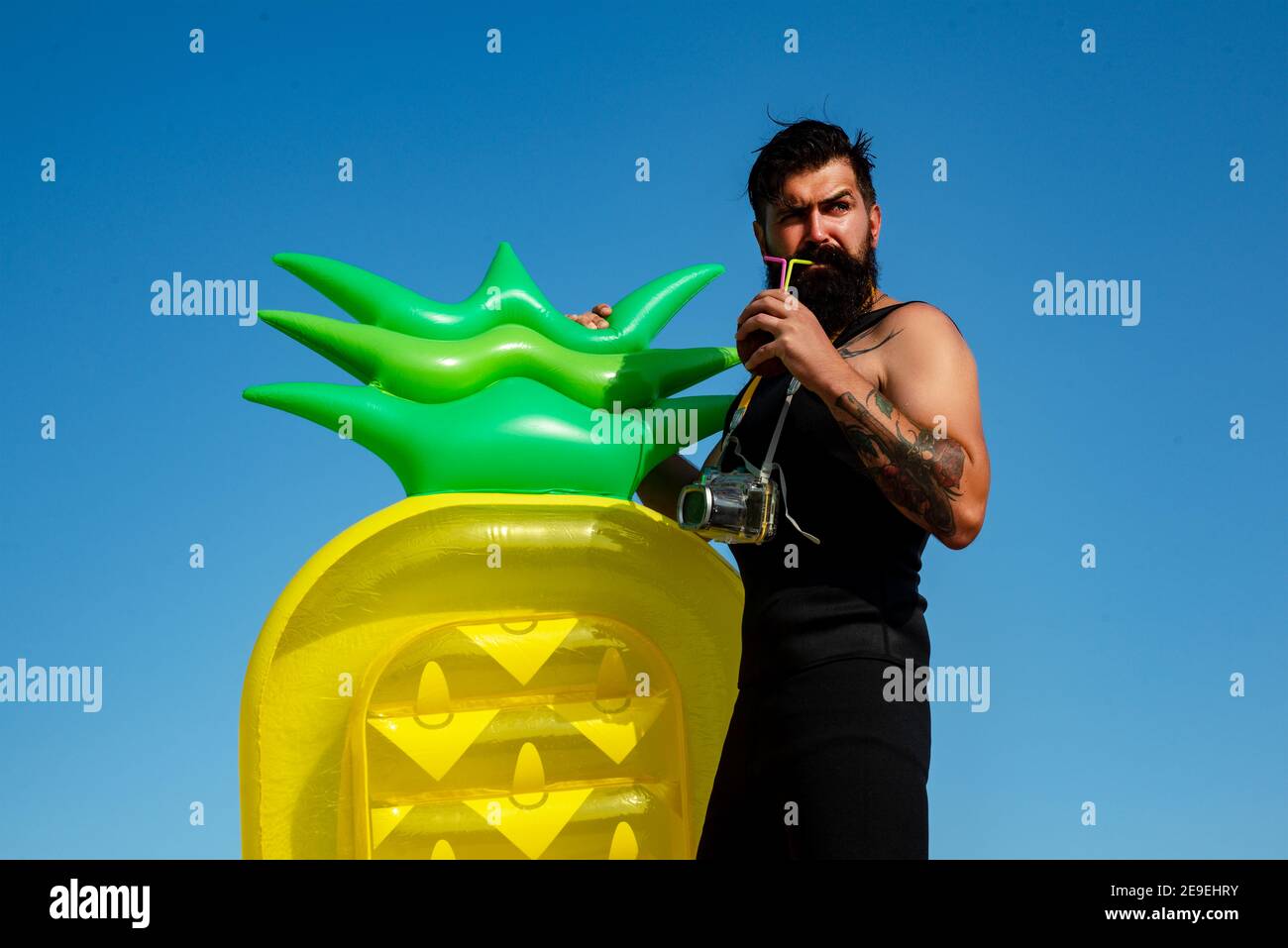Man with inflatable mattress. Handsome man in swimsuit. Guy summer ...
