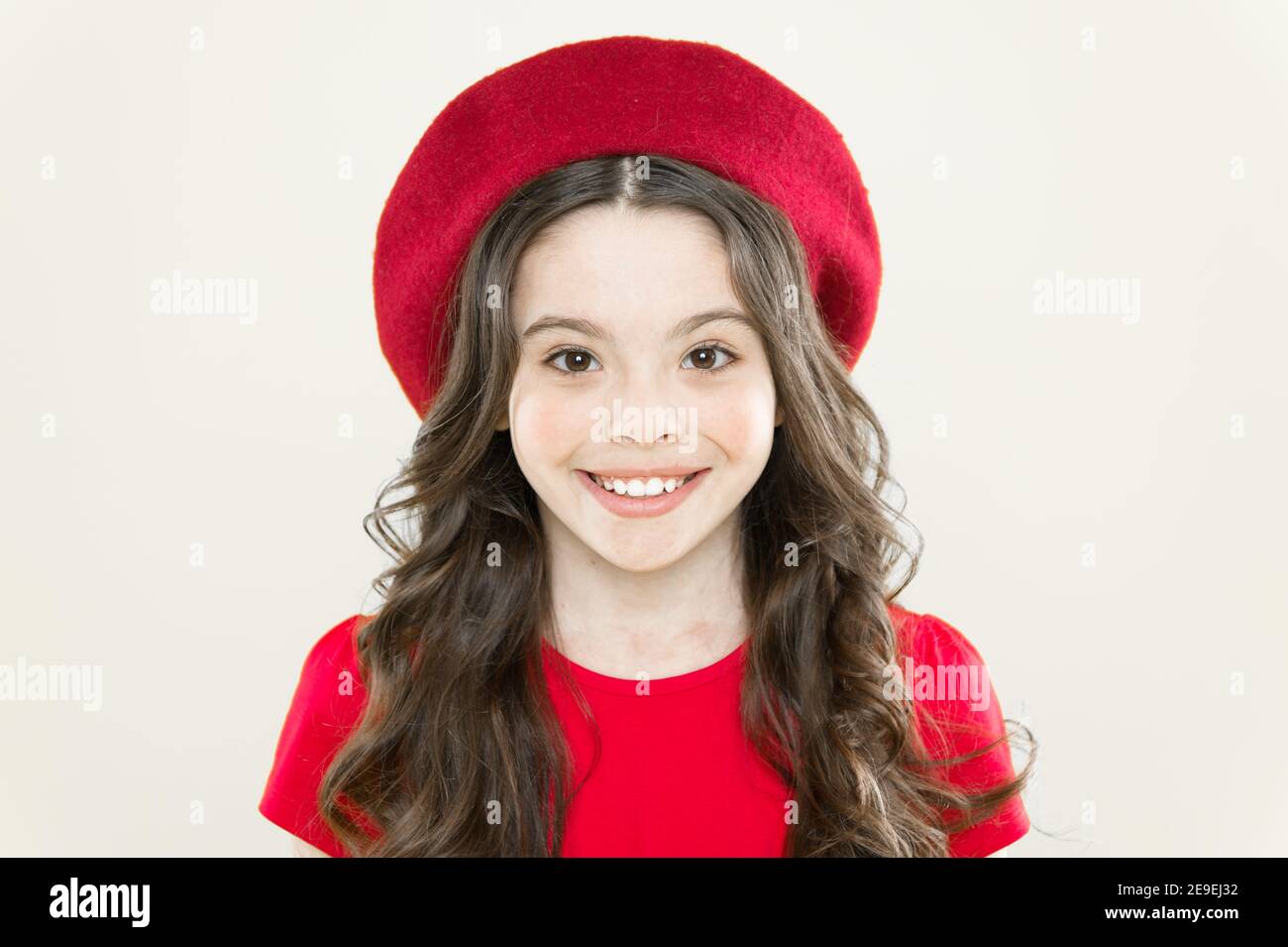 A smile on her lips. Smiling kid with white healthy smile on beautiful ...