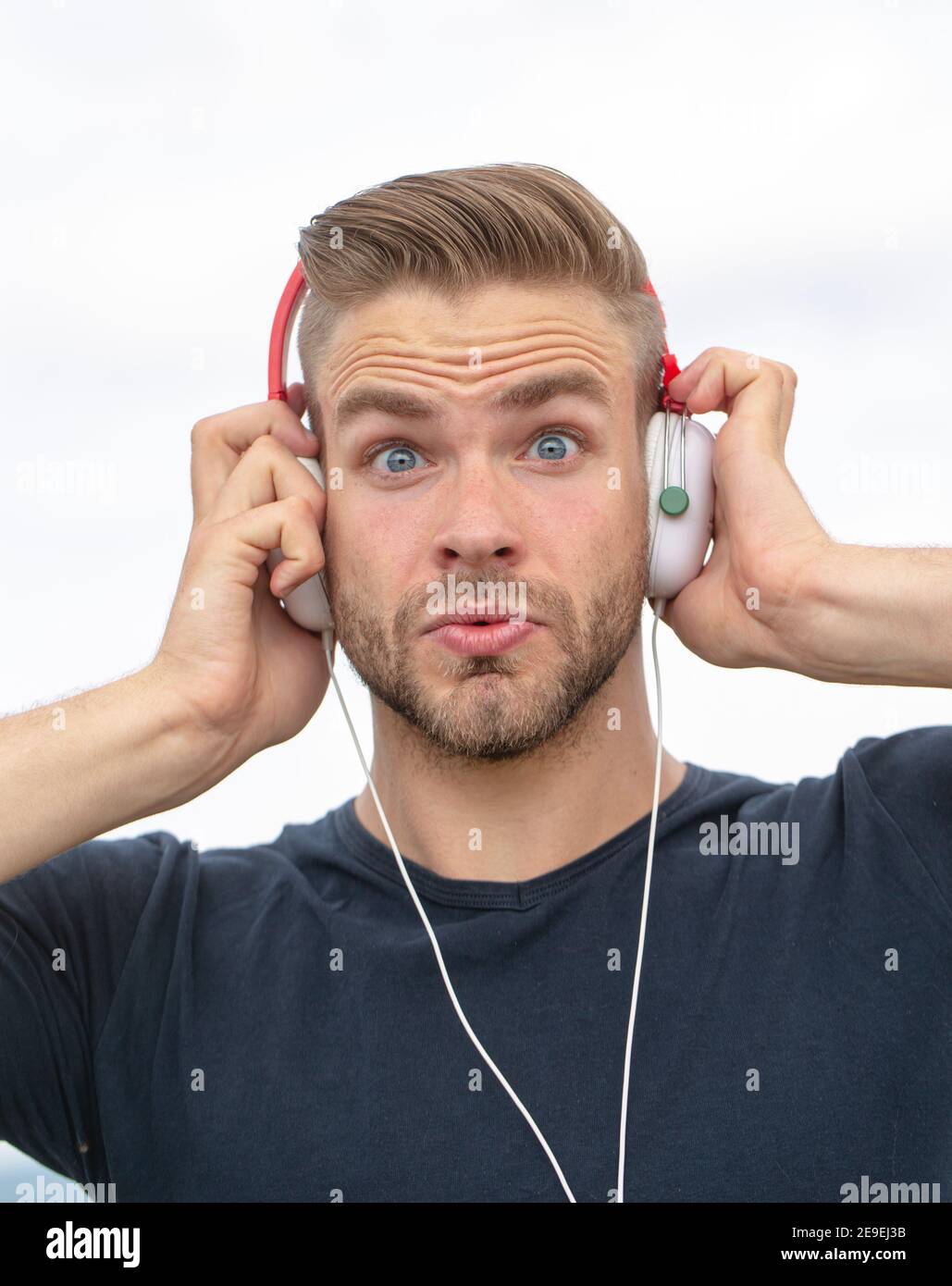 Excited Man Listening Music In Headphones Emotional Surprised Portrait