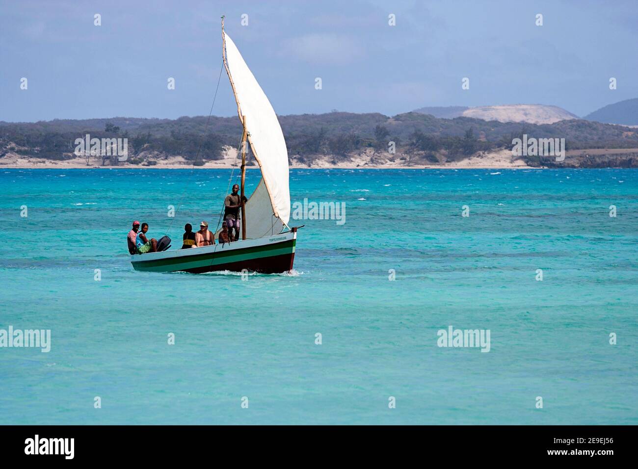 Tourists on a Wooden traditional fishing boat sailing in a turquoise ...
