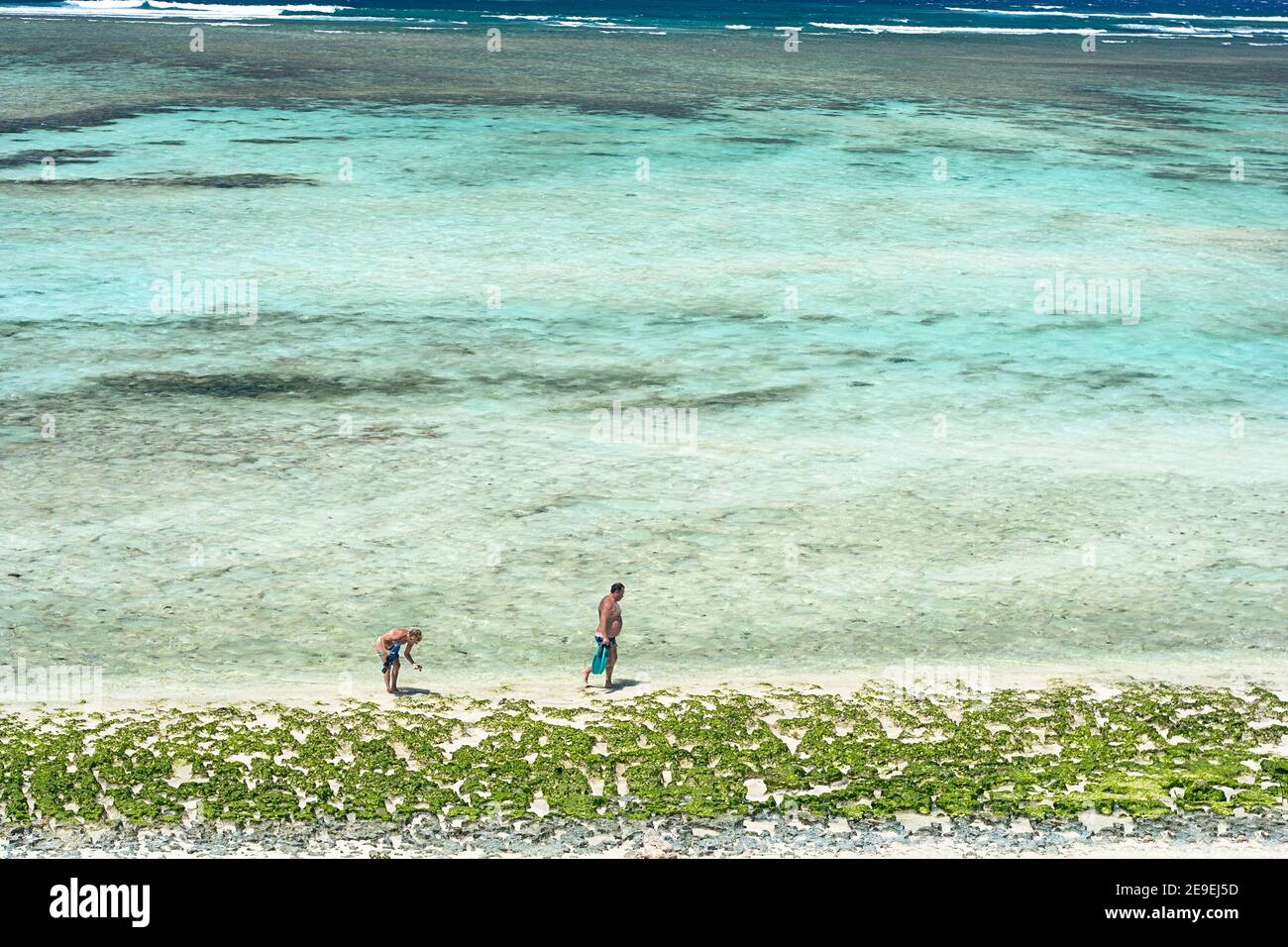 Tourists exploring beautiful Emerald Bay (Mer d'Emeraude), island ...