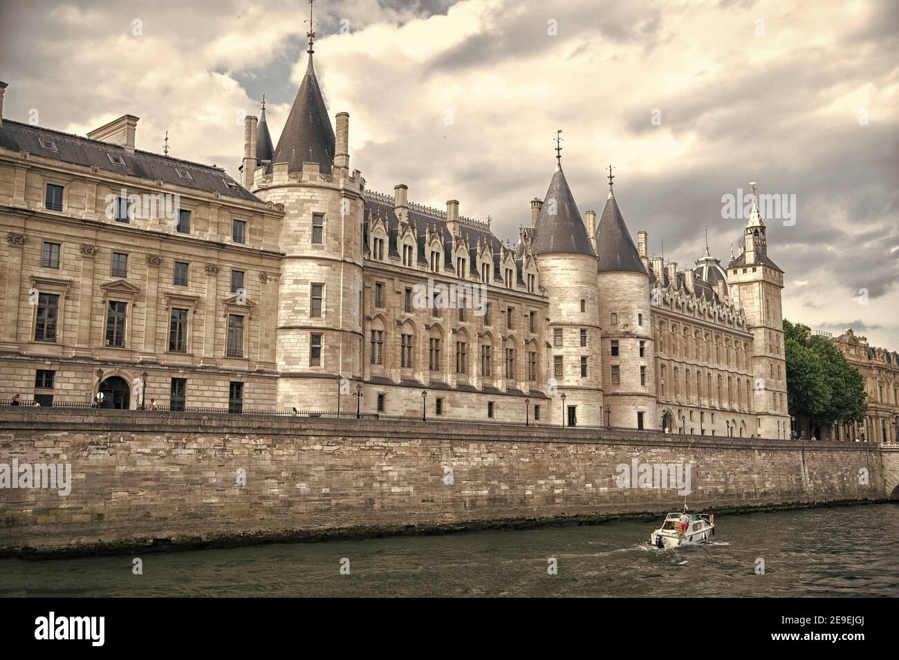 Palace on stone embankment. Boat tour. Palais de la Cite in Paris ...