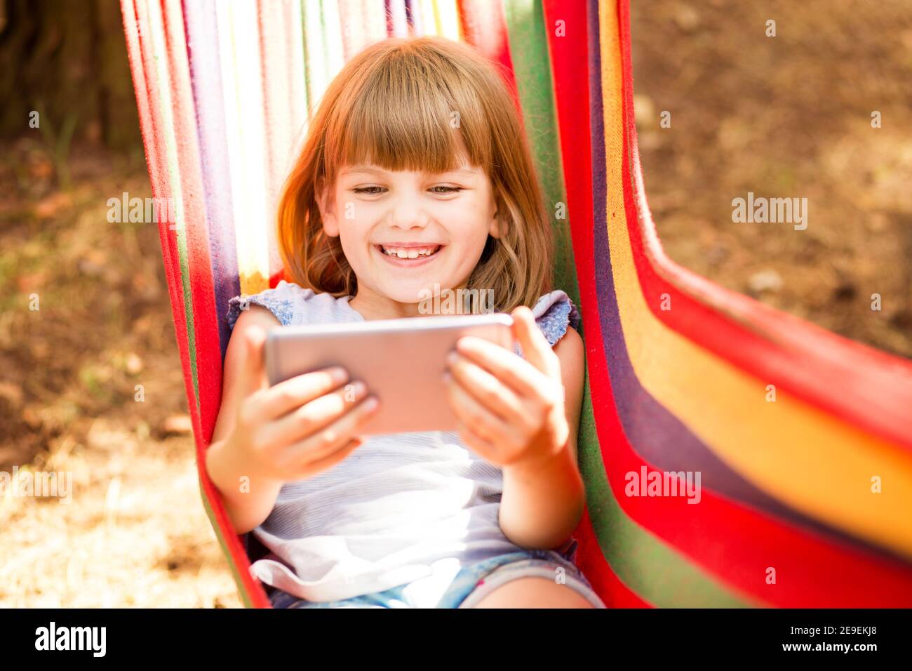 Smiling child girl recording lifestyle blog talking to camera of mobile ...