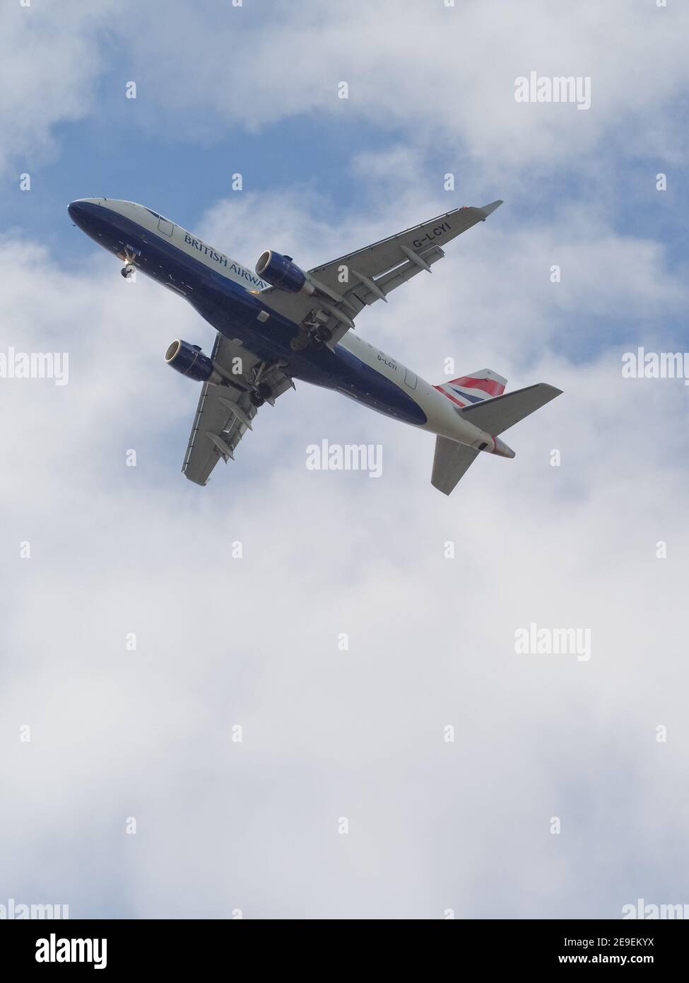 British Airways aeroplane coming into land seen from underneath against ...