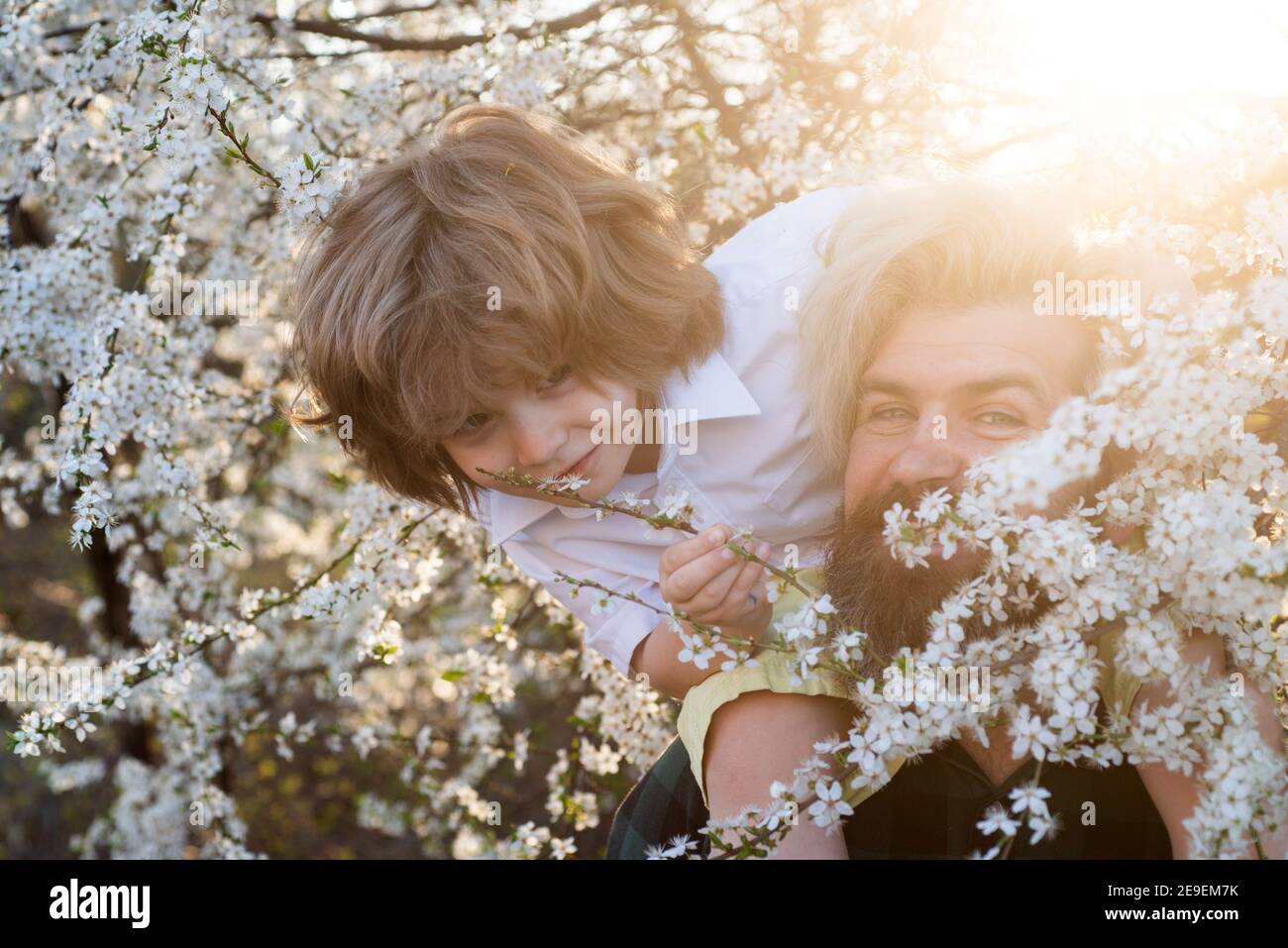Spring happy family outdoor. Child with dad in summer park. Shoulder ...