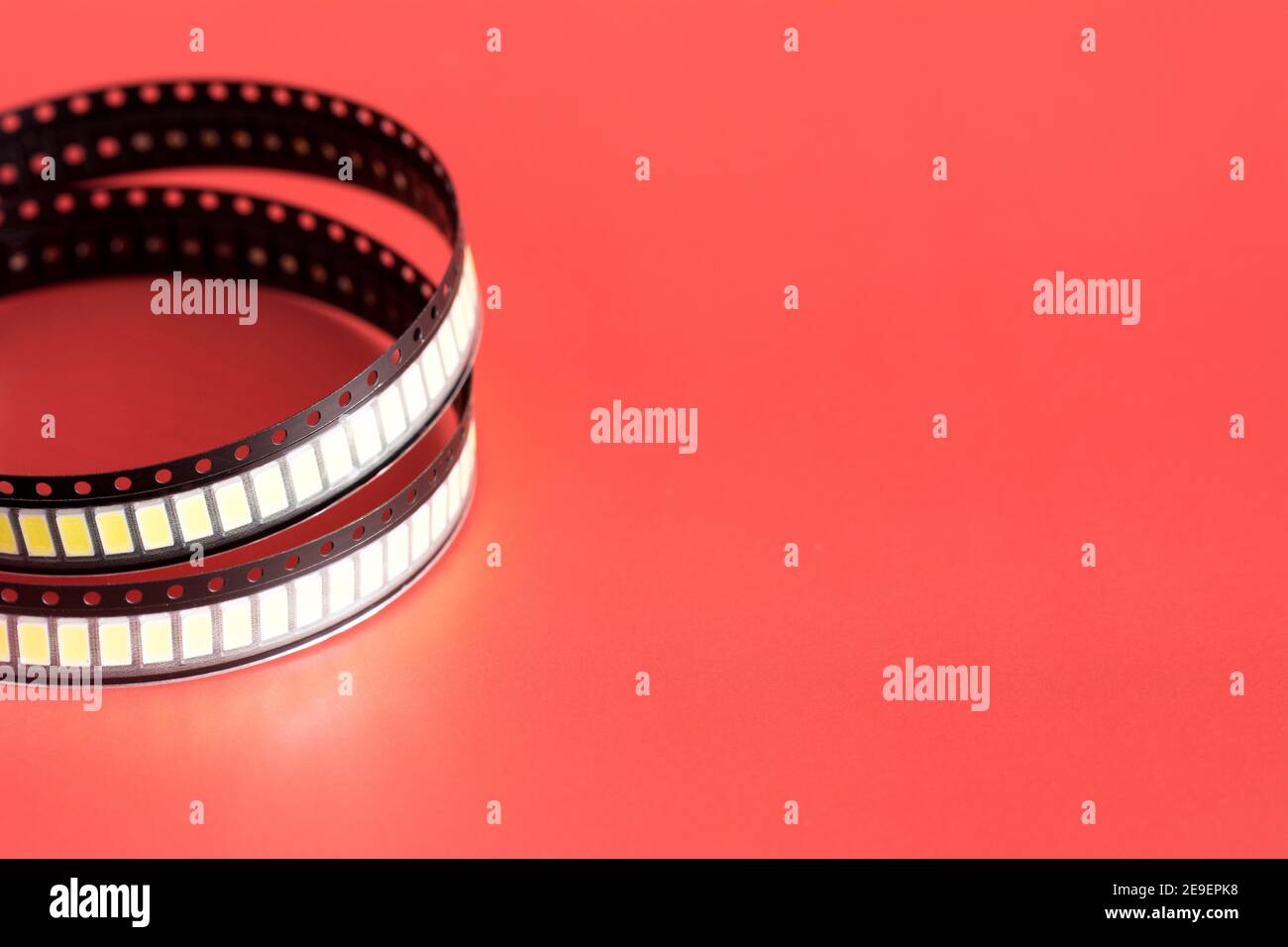 Yellow Led strip coil packaging closeup isolated on red background ...