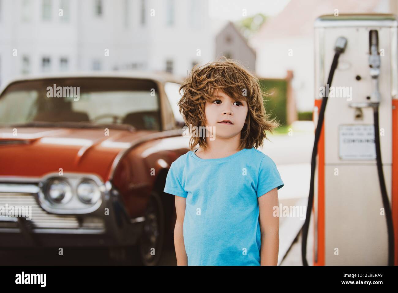 Kid at the gas station. Retro automobile Stock Photo - Alamy