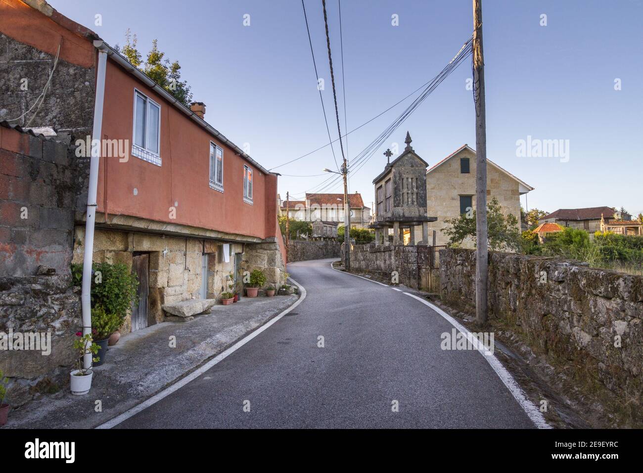 Road leading through a small town under a clear blue sky Stock Photo ...