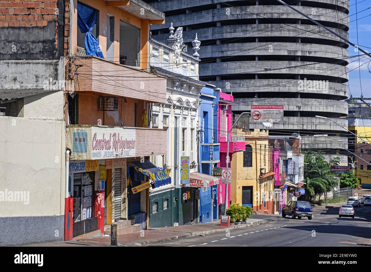 Street with colourful colonial houses among newly-built flats and ...