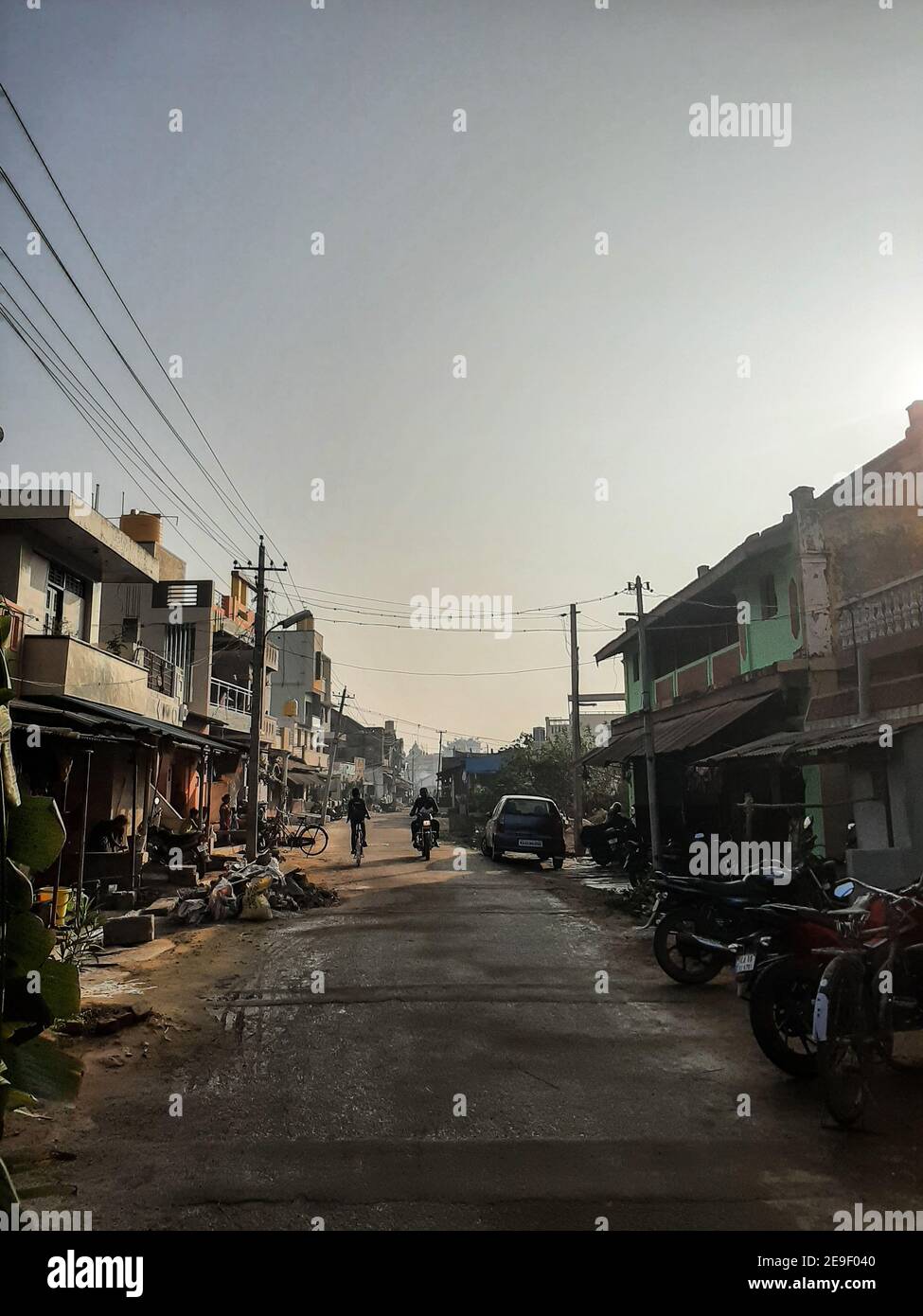 MALAVALLI, INDIA - Feb 01, 2021: a road with vehicles and buildings ...