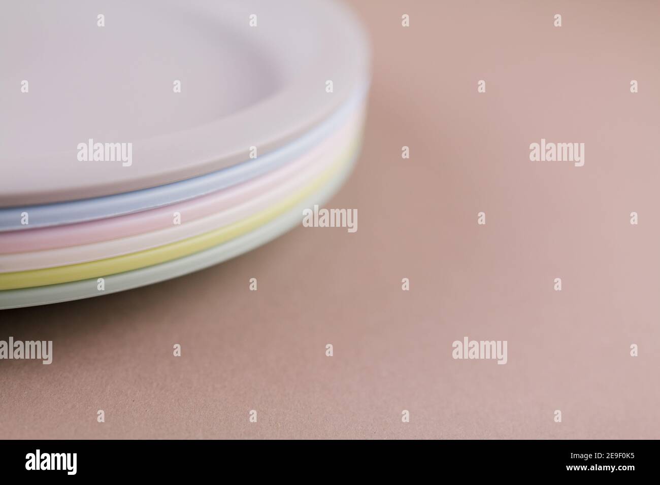a set of plastic reusable colorful plates on the kitchen table Stock ...