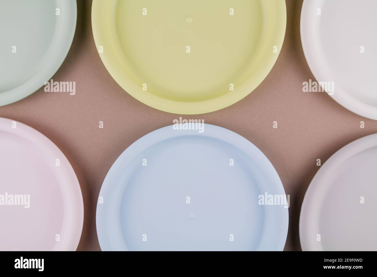 a set of plastic reusable colorful plates on the kitchen table Stock ...