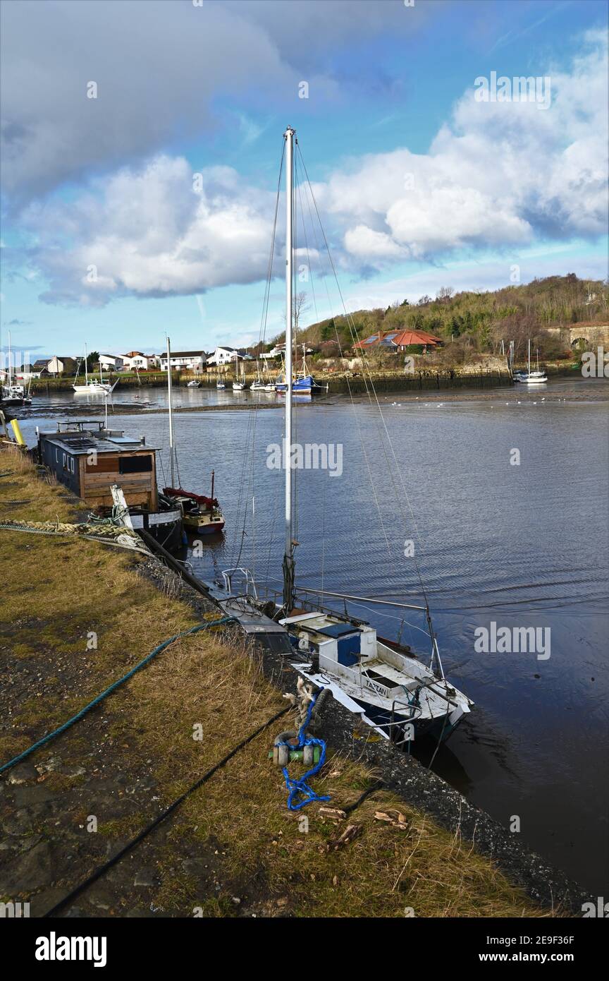 A view of a variety of small boats in a harbour at Limekilns in Fife ...