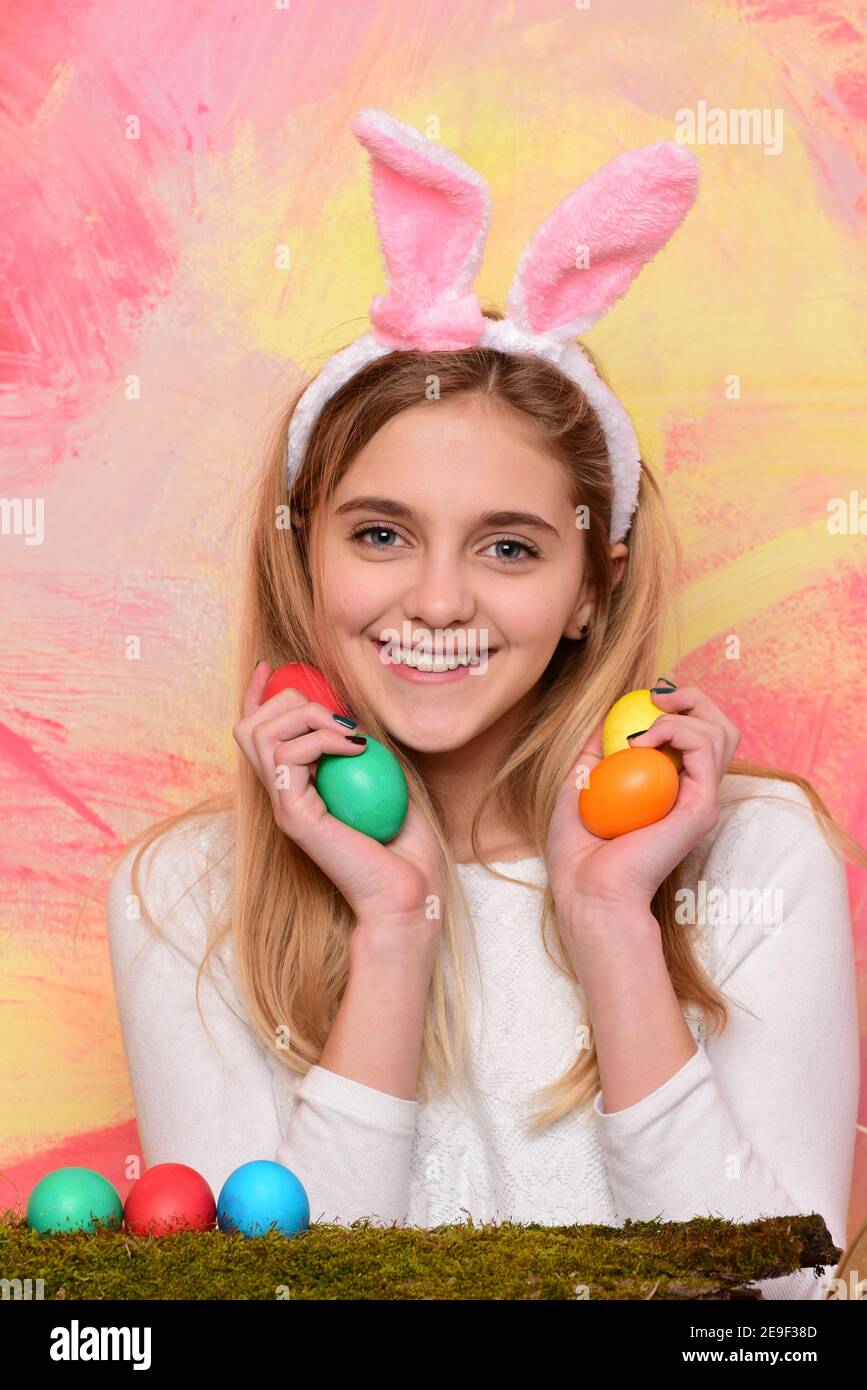 Teen in costume easter bunny rabbit with ears and eggs Stock Photo - Alamy