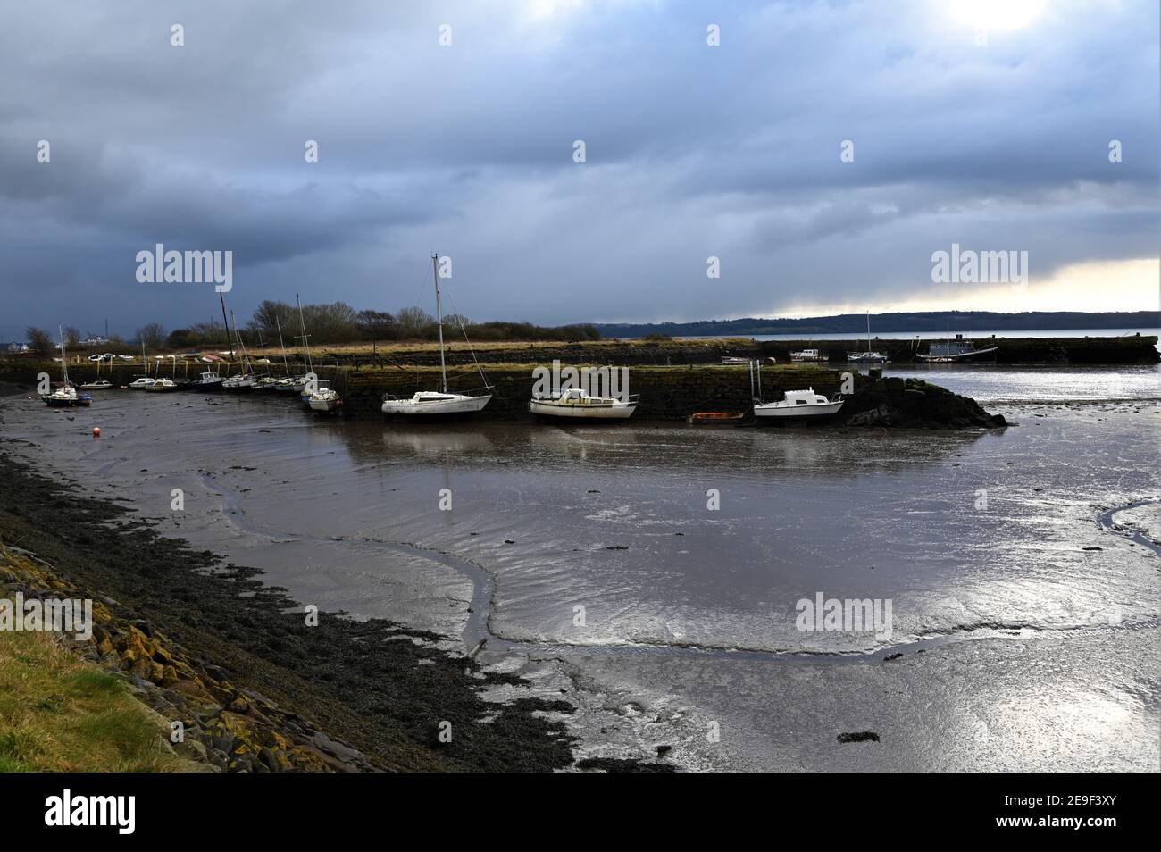 A view of a variety of small boats in a harbour at Limekilns in Fife ...