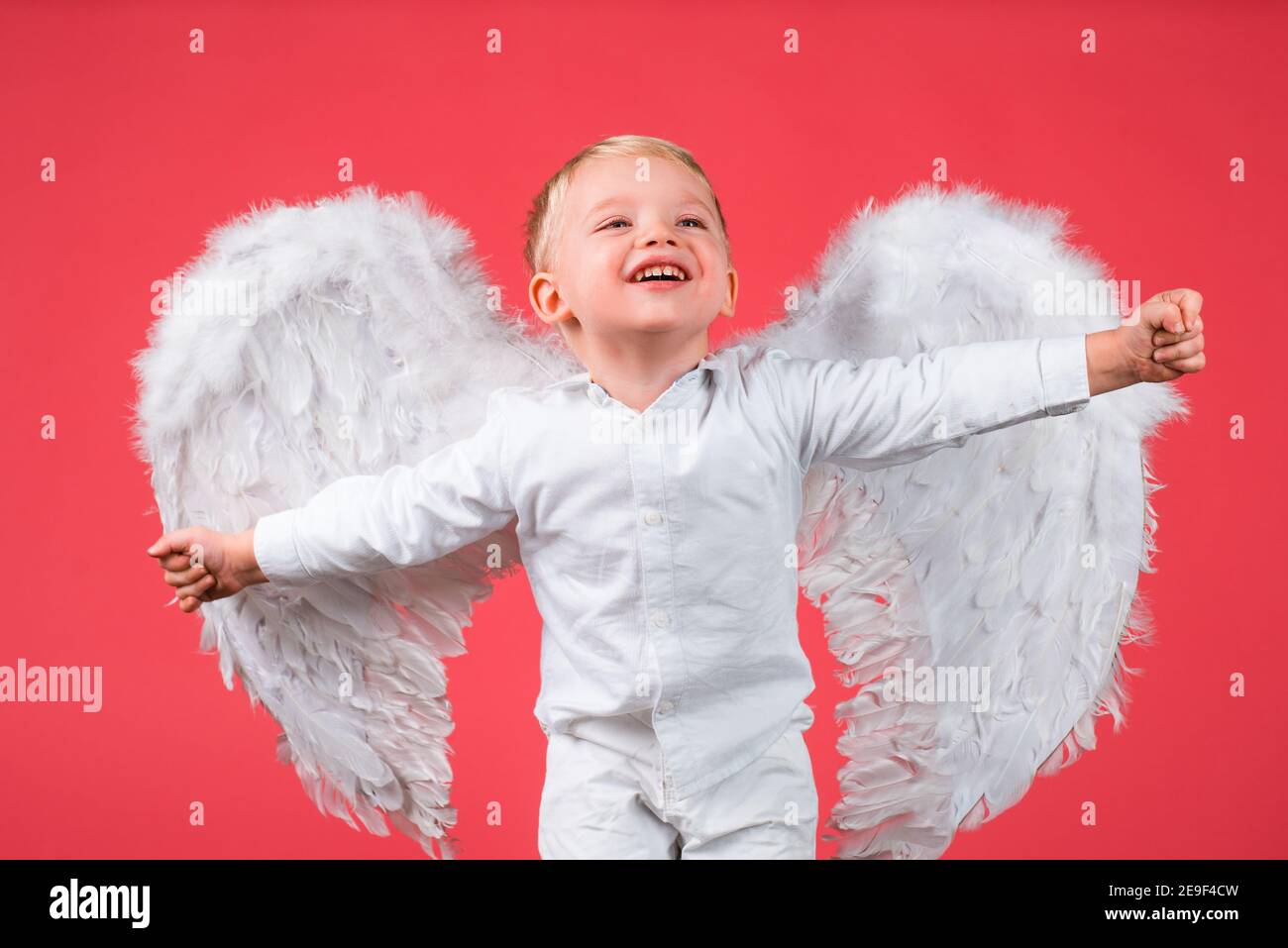 Excited angel little boy with white wings. Happy angelic children boy ...