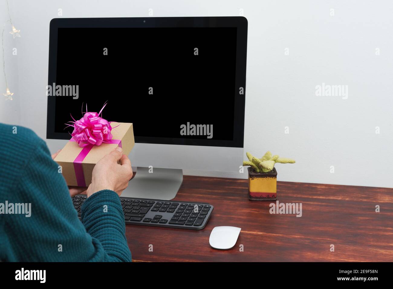 Virtual gift exchange. Man offering gift in front of computer. Moc ...
