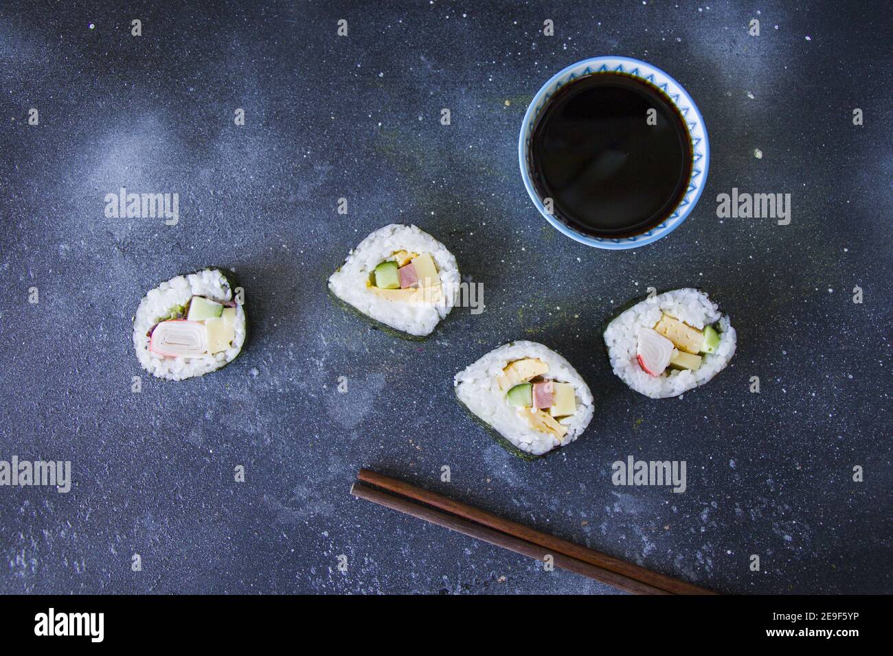 Top view of kimbap with soy souse on a blue surface Stock Photo - Alamy