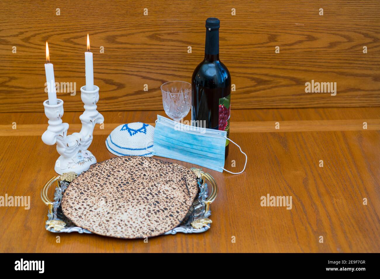 Corona Passover. Dust mask, bottle of wine and matzah - a traditional ...
